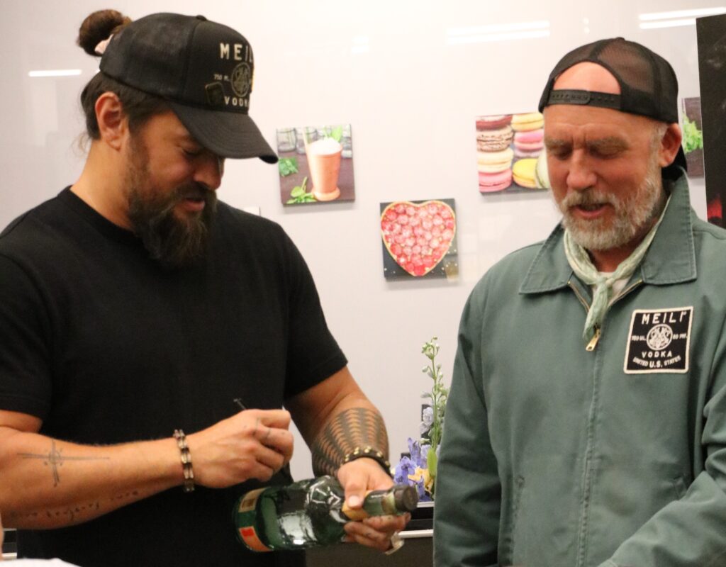Jason Momoa and Blaine Halvorson Sign bottles to promote Meili Vodka